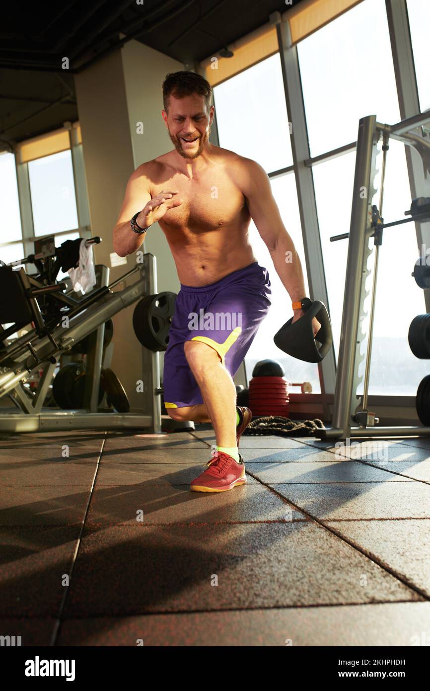 Handsome Athletic Men Exercising With Kettlebell in the gym Stock Photo ...