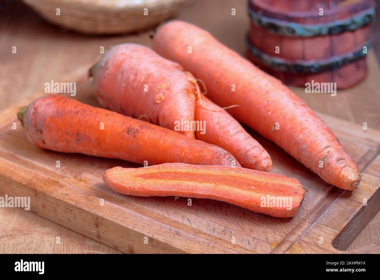carrot - red carrots on a cutting board and one cut in half, on the ...