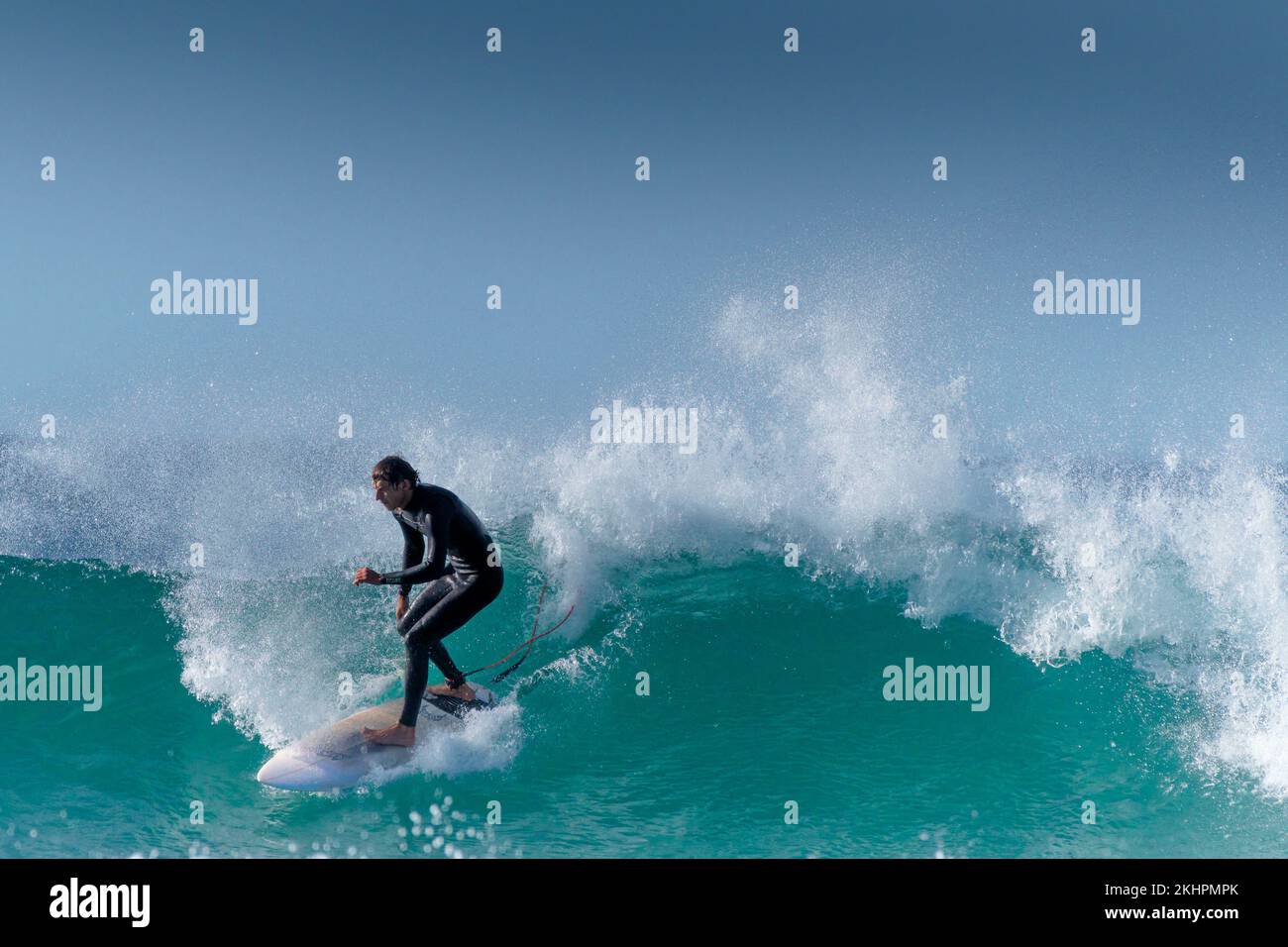 Spectaular surfing action as a male surfer rides a wave at Fistral in ...