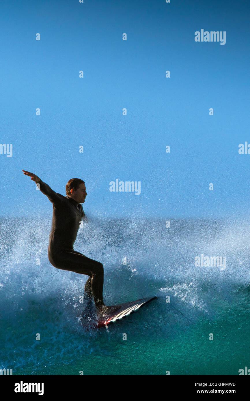 Spectaular surfing action as a male surfer rides a wave at Fistral in ...