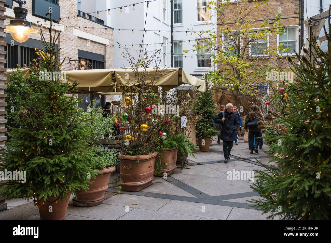 People passing through Floral Court which is set out with decorated ...