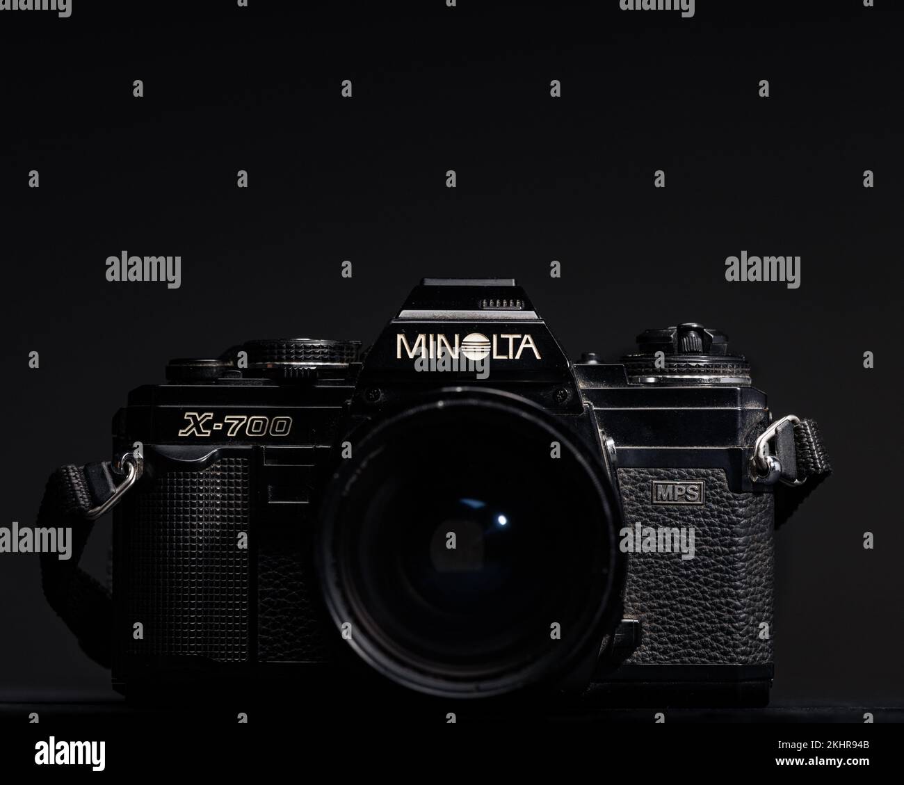 A Minolta x700 vintage film camera against a black background in a ...