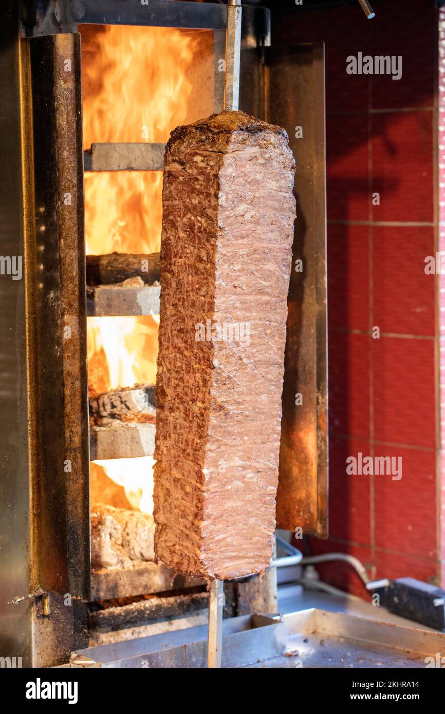 Doner kebab cooked in wood fire. Turkish doner kebab Stock Photo - Alamy