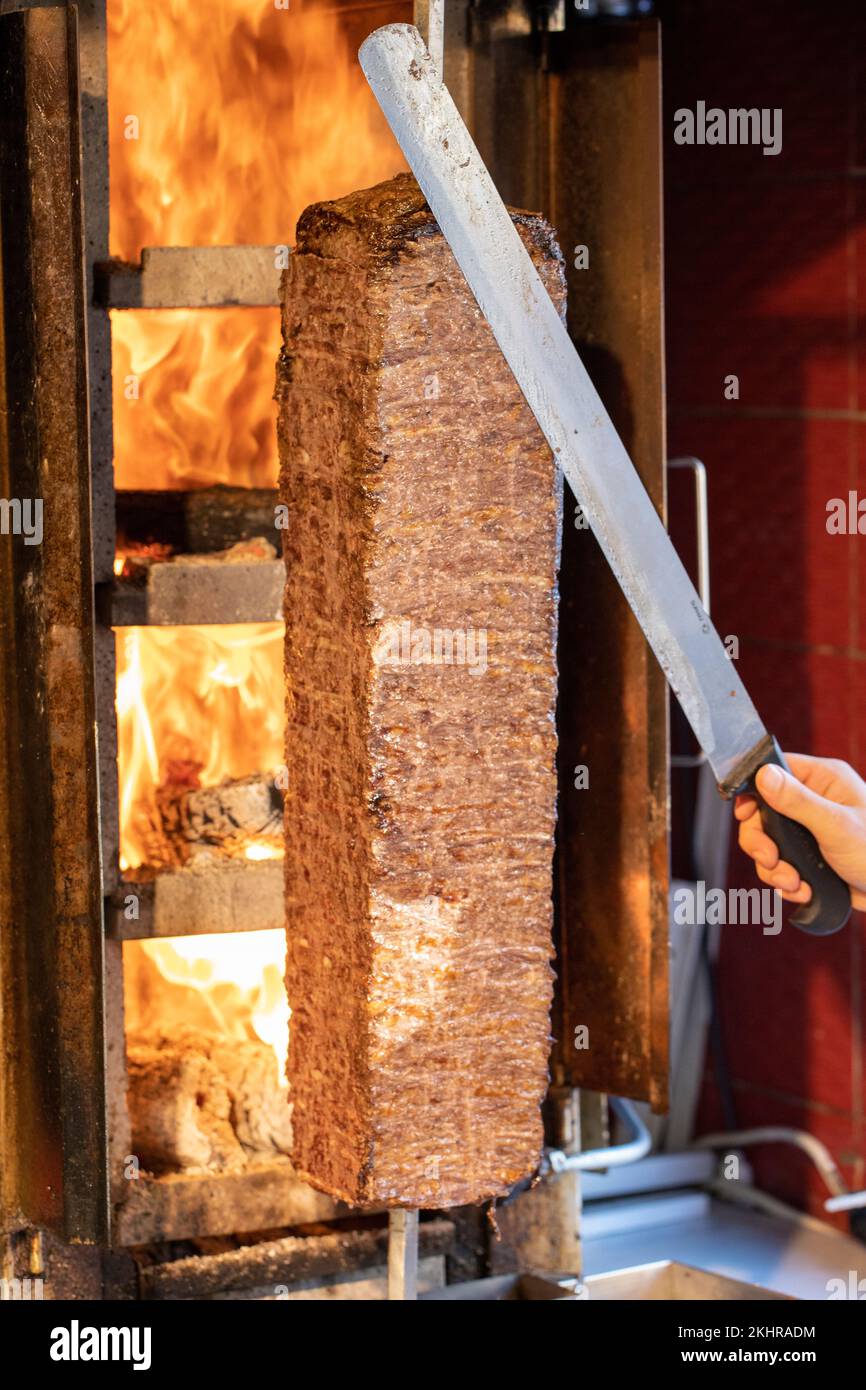 Doner kebab cooked in wood fire. Turkish doner kebab Stock Photo - Alamy