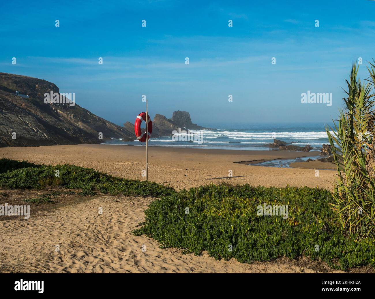View of empty Praia da Zambujeira do Mar golden sand beach with ocean ...