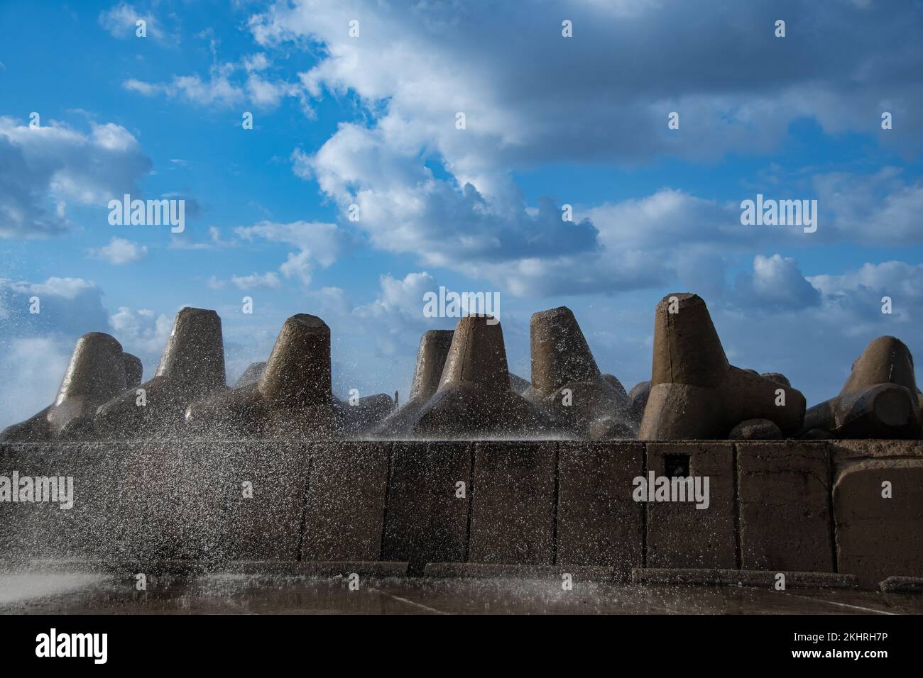 Water splashes over concrete breakwater Stock Photo - Alamy