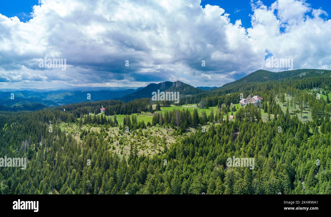 Valley of Balkan mountains with fog, sunny clouds and forests. Village ...