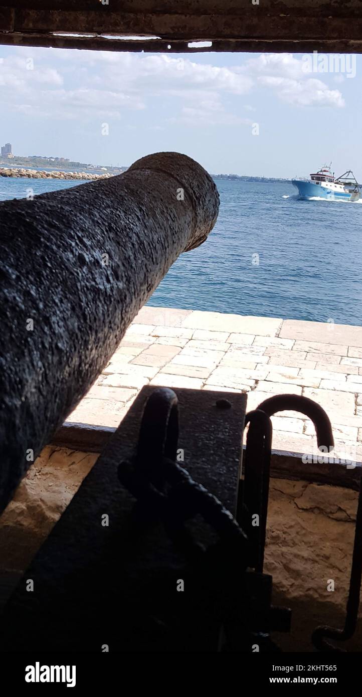 A vertical shot of a cannon in the guard post of the Castel San Angelo ...