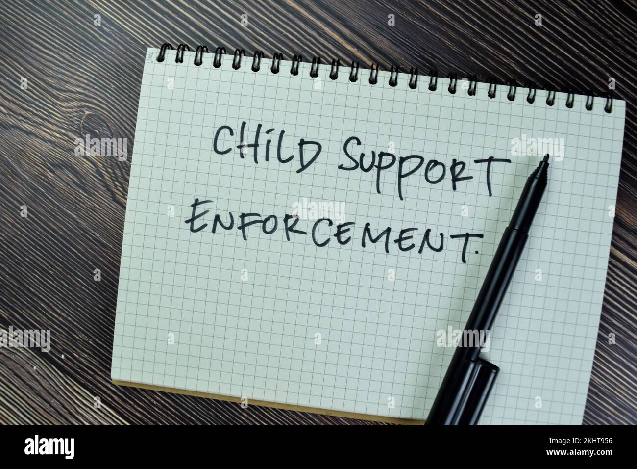Concept of Child Support Enforcement write on a book isolated on Wooden ...