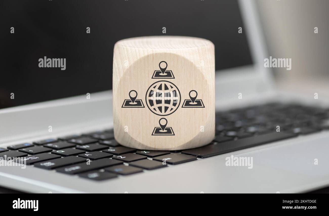 Wooden block with symbol of globalization concept on laptop keyboard ...