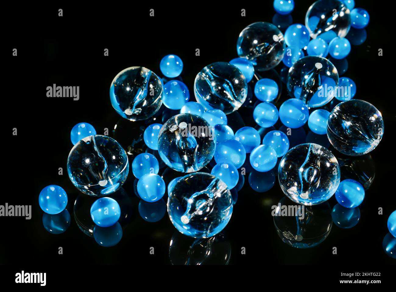 blue beads balls on black mirror background Stock Photo - Alamy