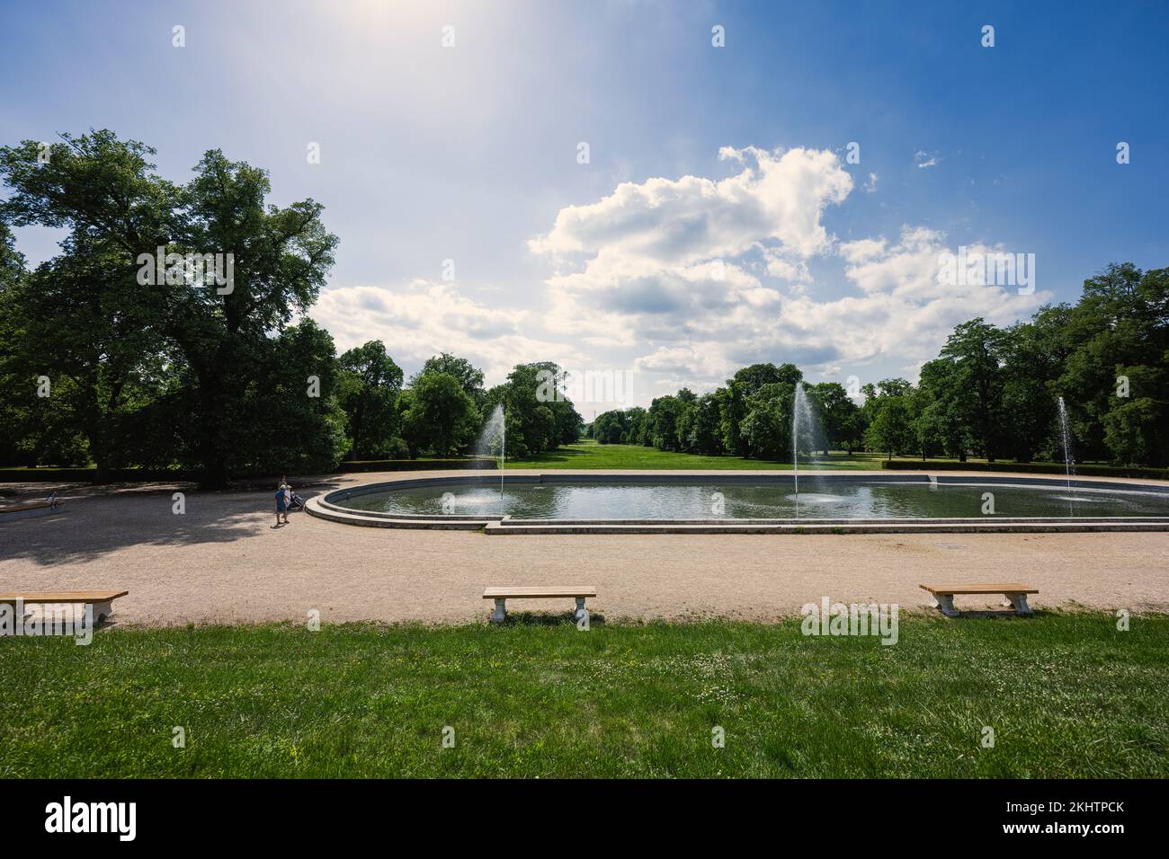 Mother with kids near fountain of Slavkov Castle, also known as ...