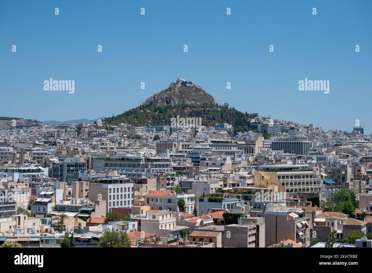 A beautiful scenery of city buildings with a mountain in the distance ...
