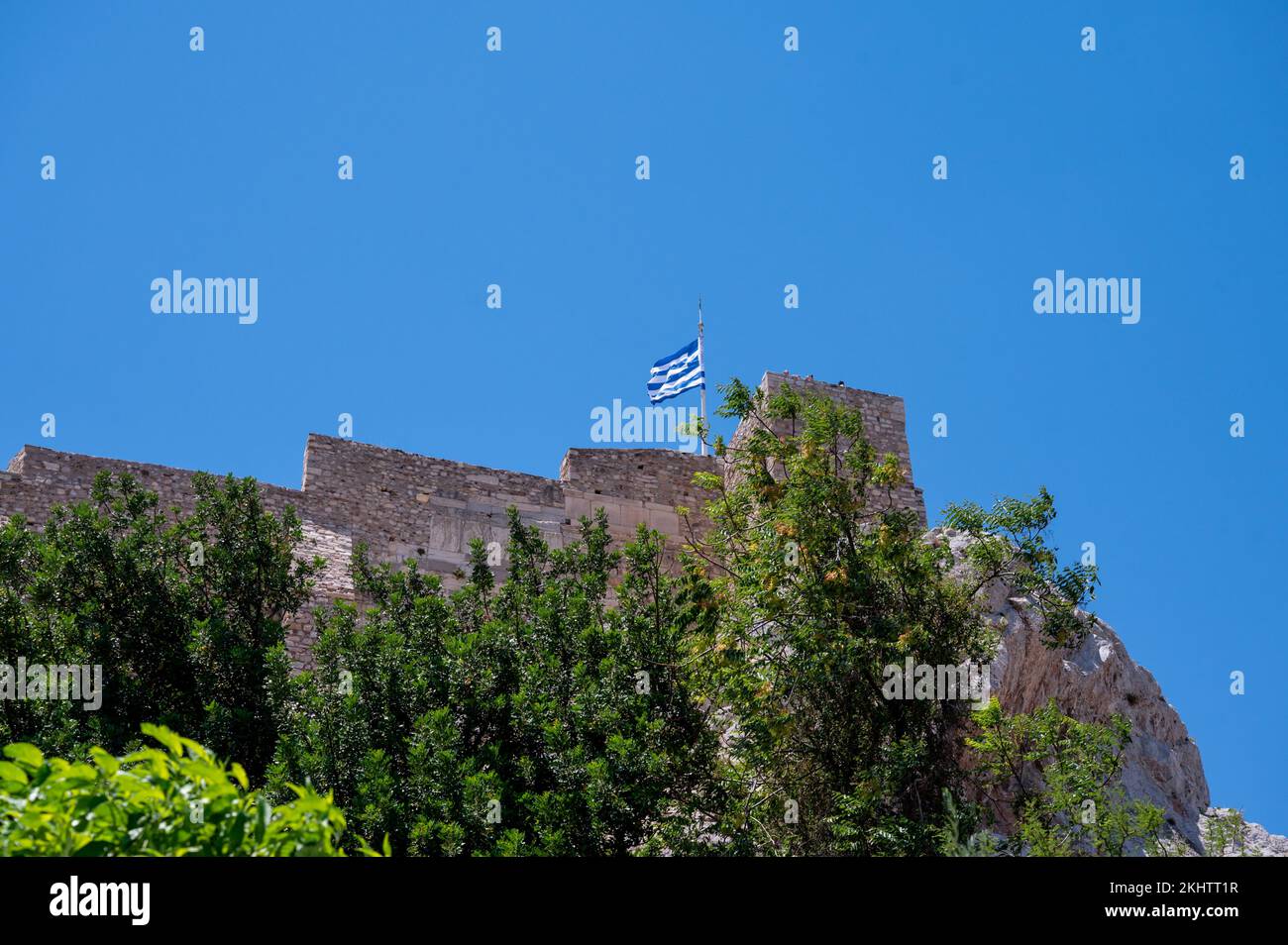 A low angle shot of the Castle of Monolithos with a Greece flag Stock ...