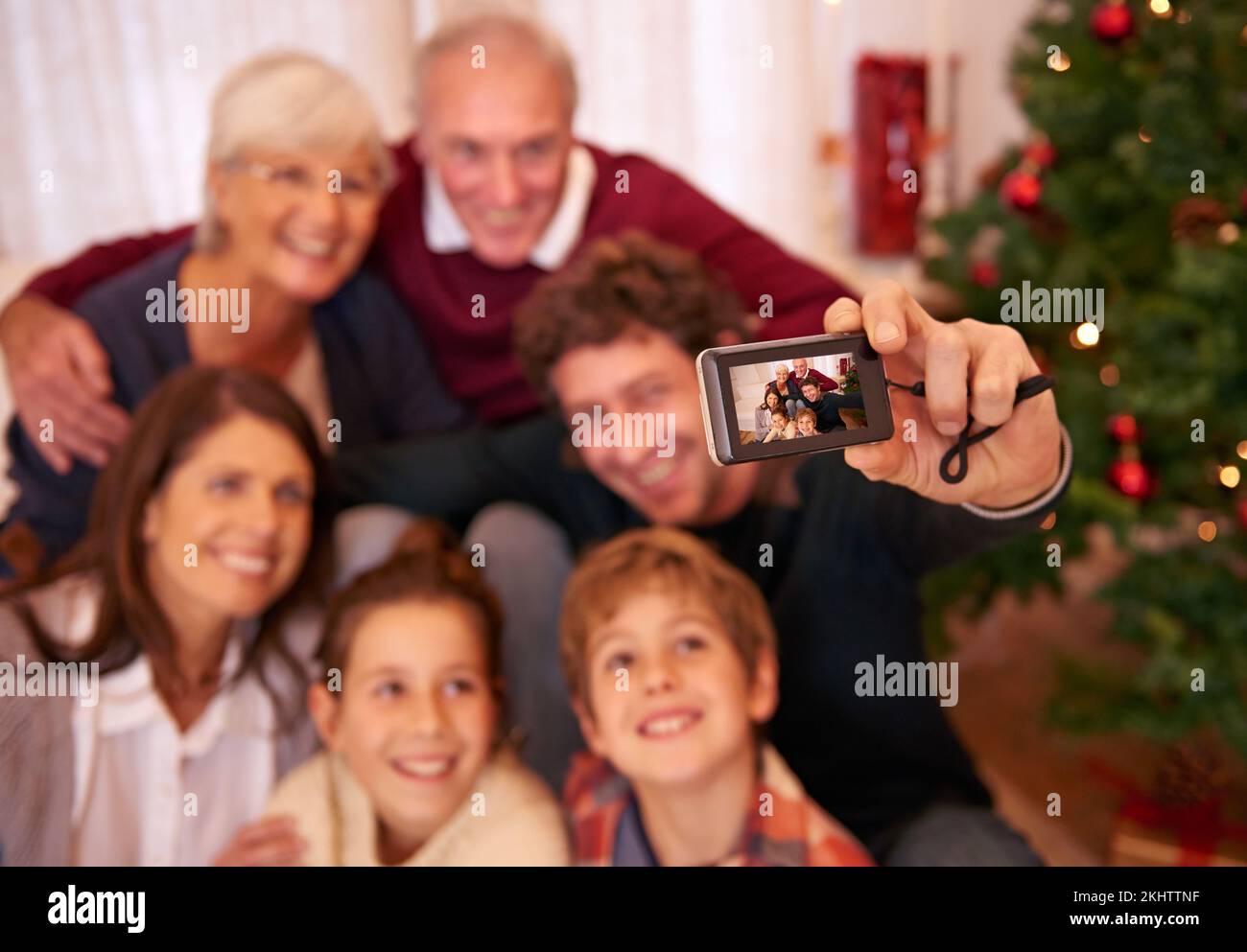 Happy, family, camera and selfie in living room for christmas, bonding ...