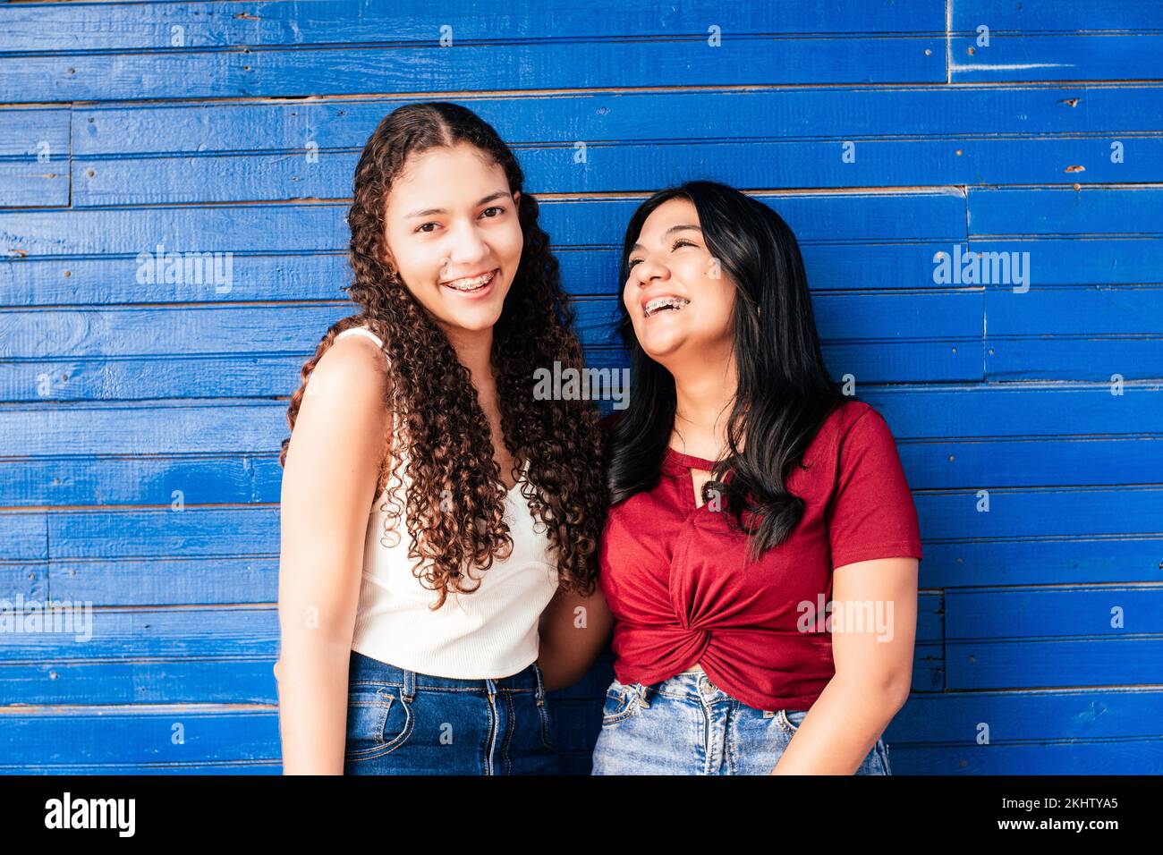 The two Hispanic friends with brackets laughing together Stock Photo ...