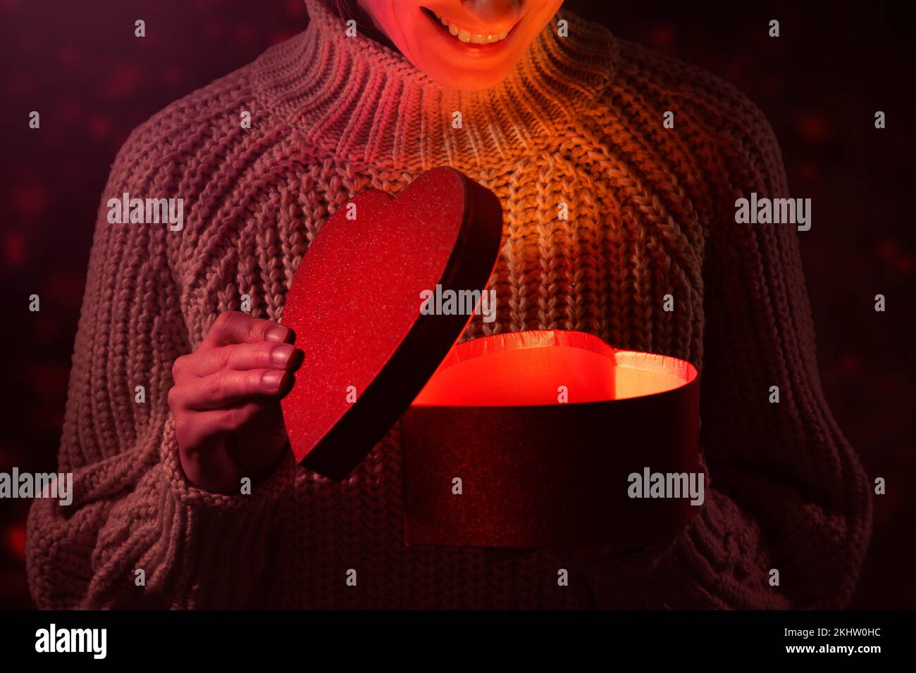 woman open a heart shaped gift box. romantic anniversary or valentine's ...