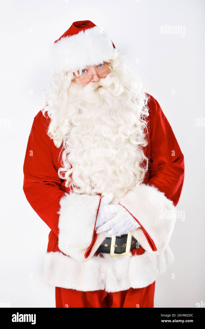 Portrait of father Christmas in studio with white background in a red ...
