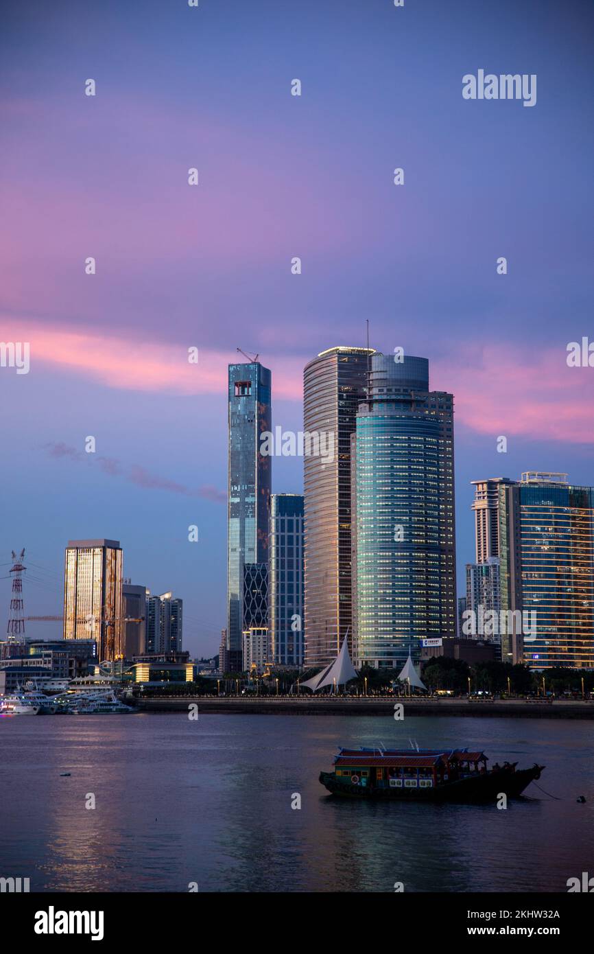 A vertical shot of beautiful modern skyscrapers with a beautiful sunset ...
