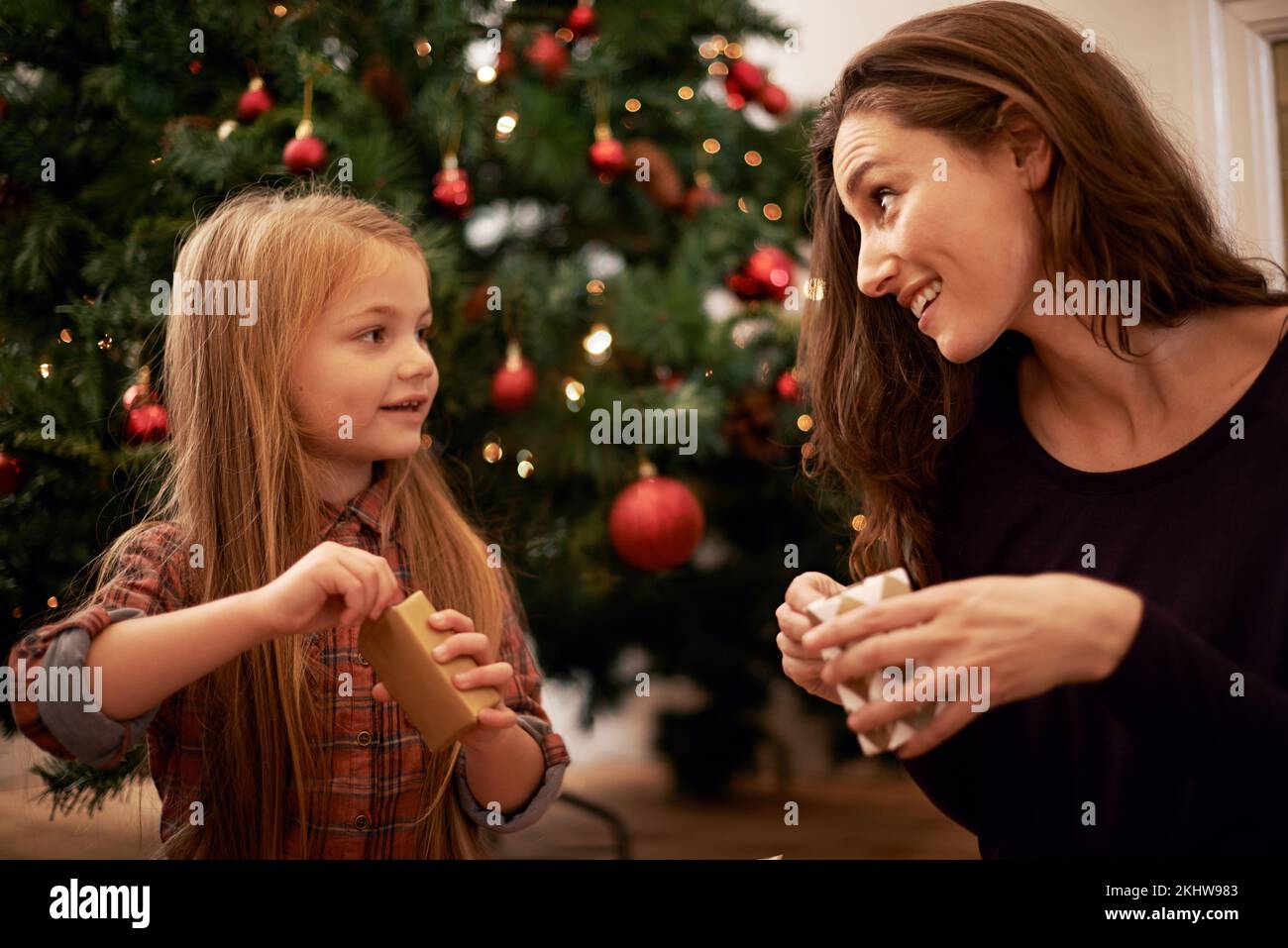 Christmas gifts, family and mother with girl, having fun or bonding in ...