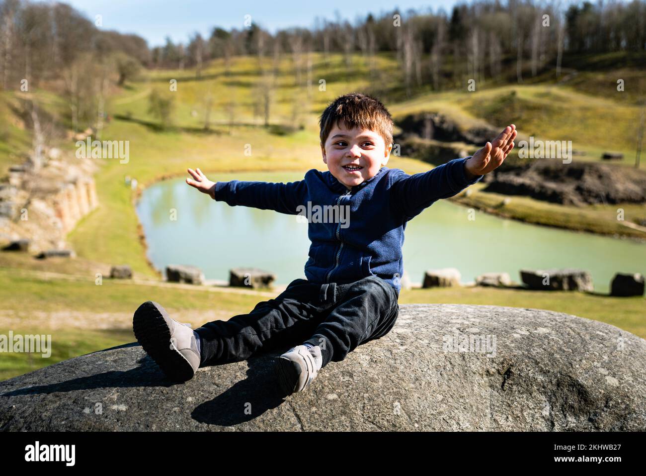 Happy kid with open arms pretending to be a plane is engaging in a ...