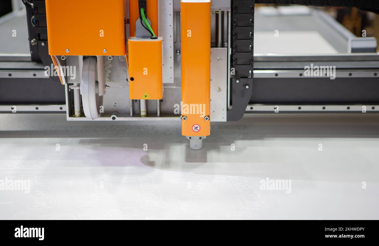 Digital die cut machine cutting plastic sheet. Industrial manufacture ...