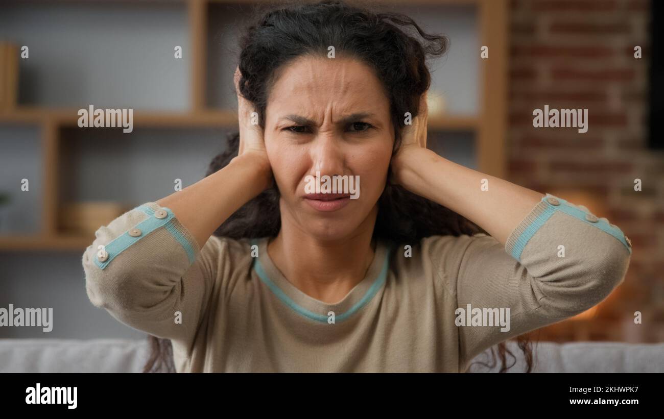 Portrait Hispanic Caucasian woman irritated distraught girl sitting at ...