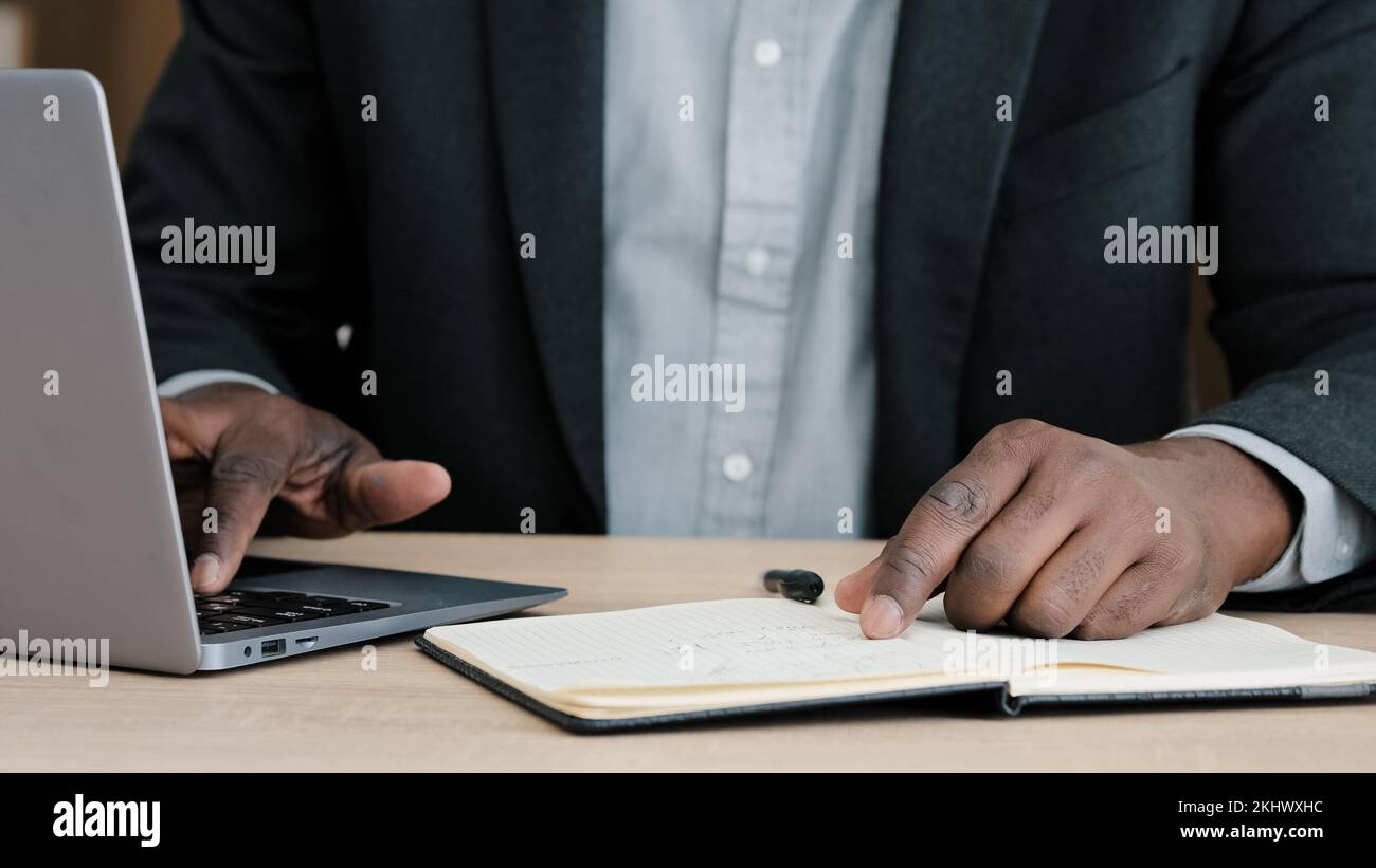 Close-up male hands writing in notebook with pen make notes information ...