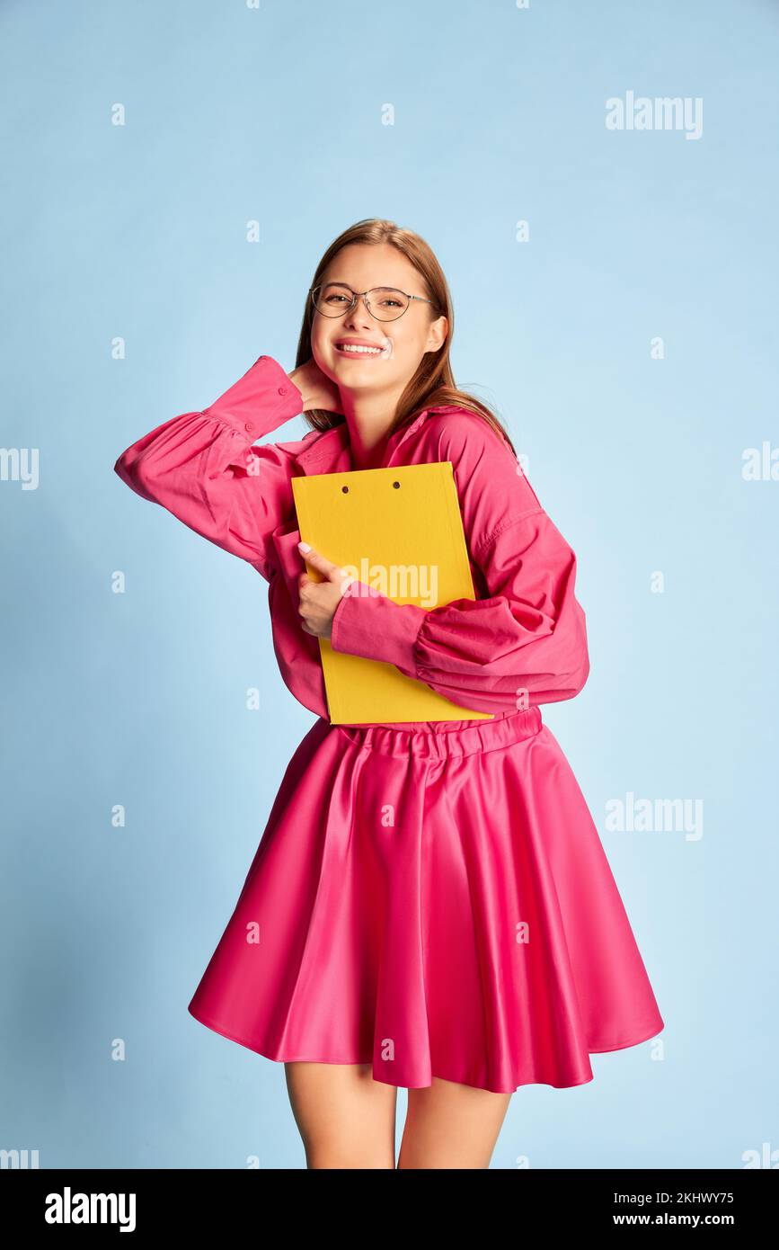 Portrait of young beautiful girl in stylish pink dress posing isolated ...