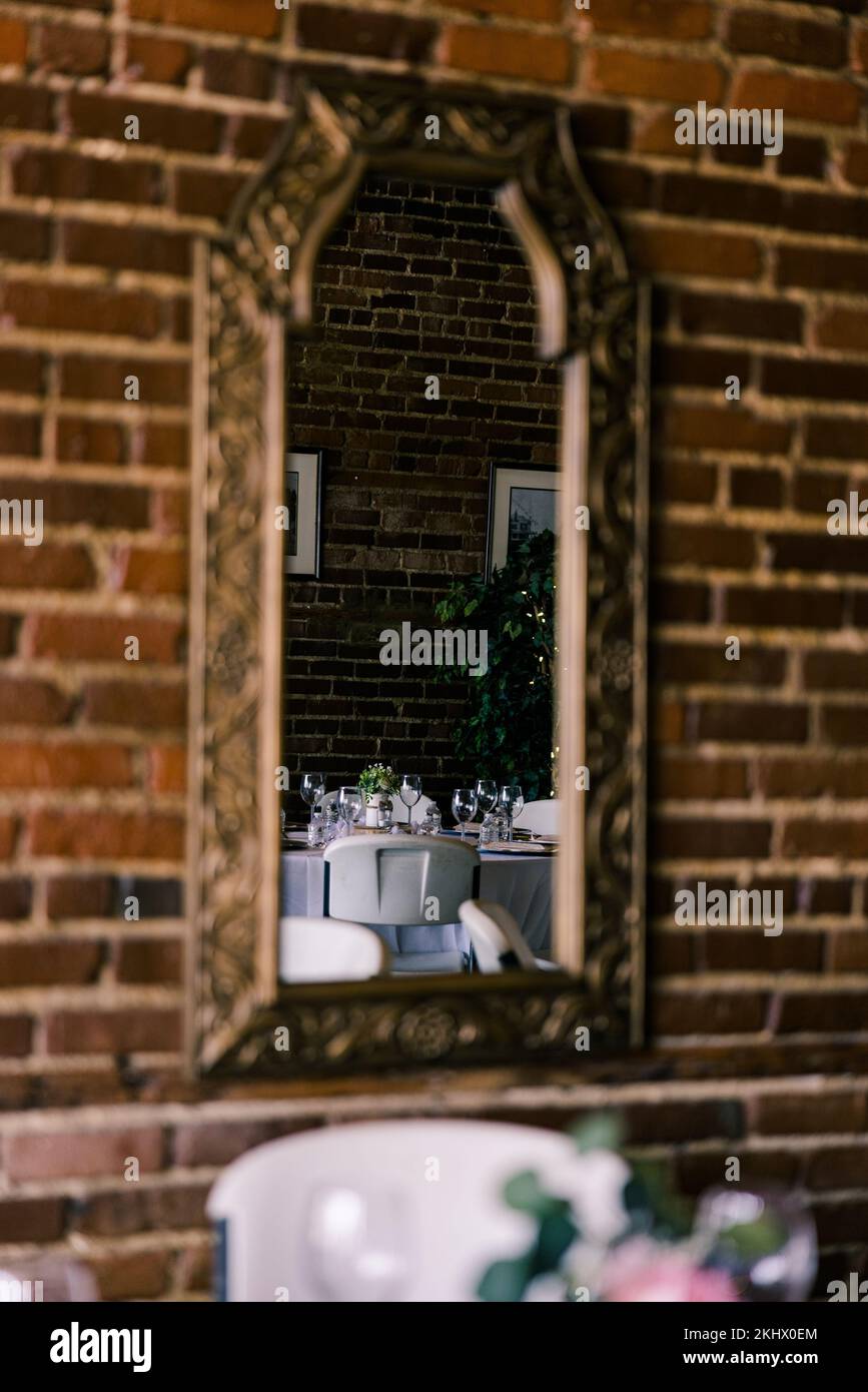 An elegant table setting in a wedding reception reflecting on a mirror ...