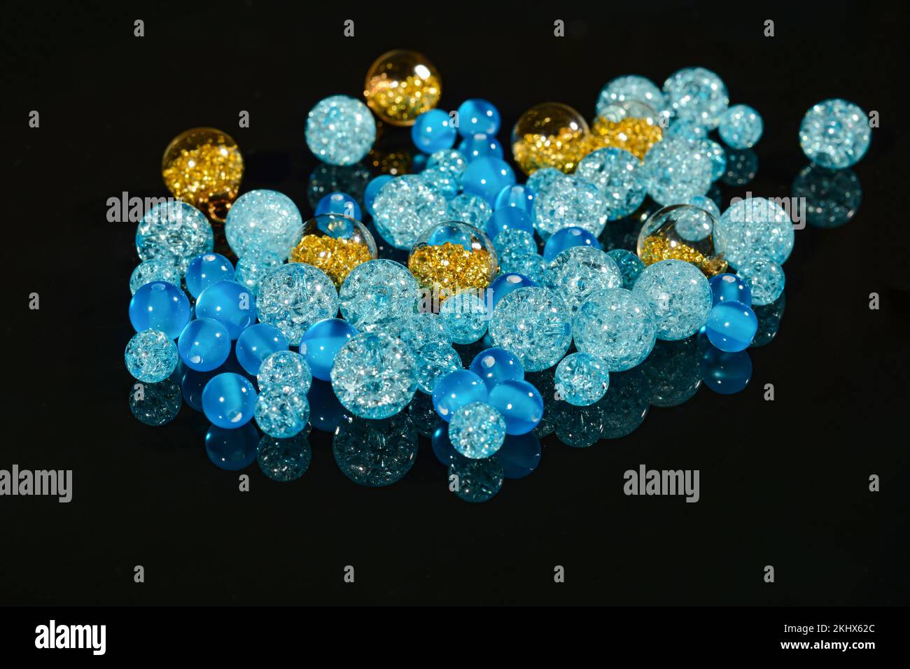 blue beads balls on black mirror background Stock Photo - Alamy