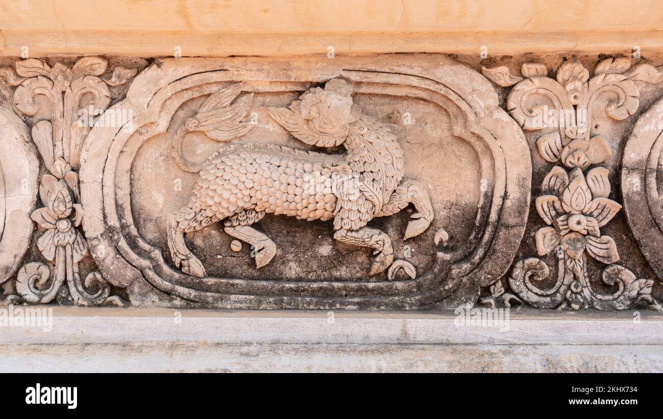 Ancient bas-relief stucco of mythological animal with hooves and scales ...