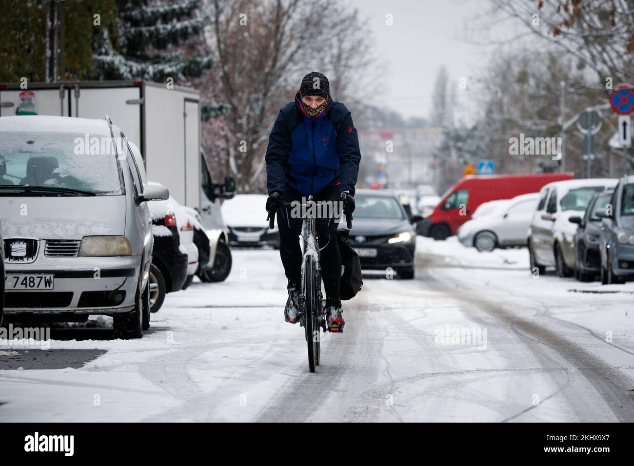 A man is seen cycling on a snow covered road in Warsaw, Poland on 24 ...