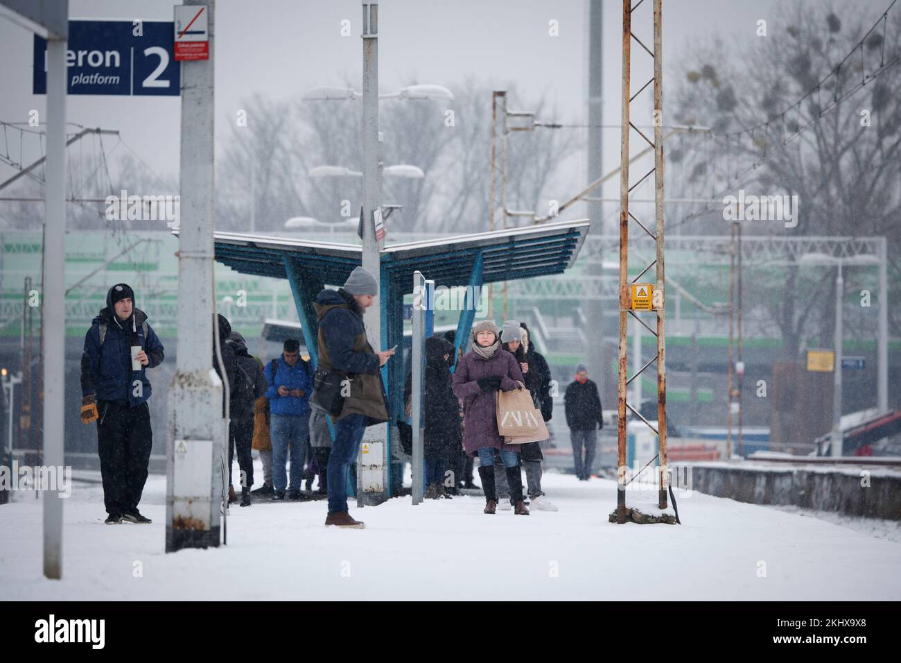 Commuters are seen waiting for a train at a train station in Warsaw ...