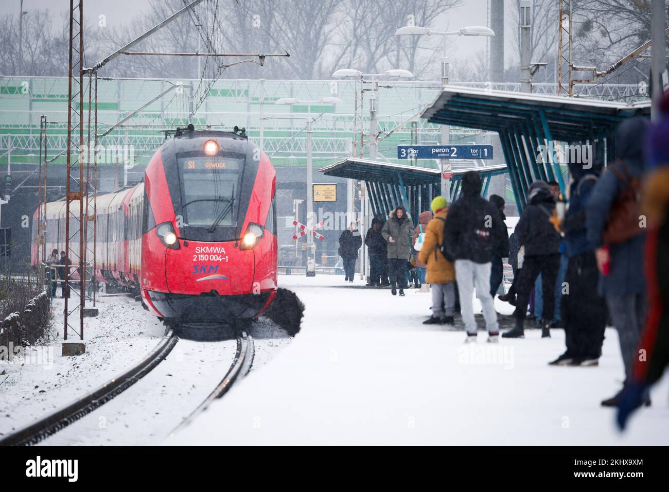 Commuters are seen waiting for a train at a train station in Warsaw ...