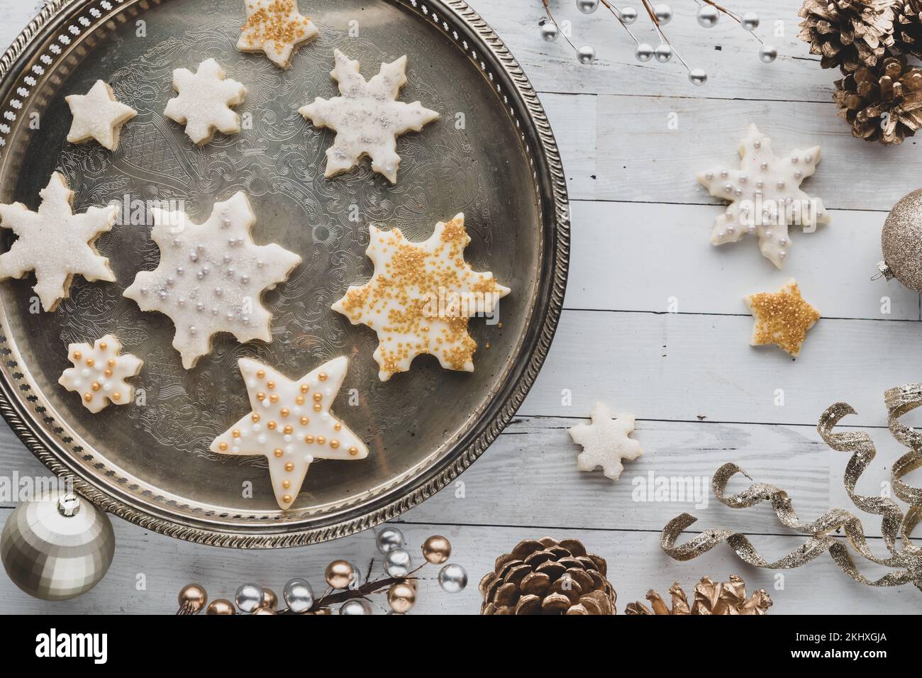 Star and snowflake shaped sugar cookies on a vintage platter with ...