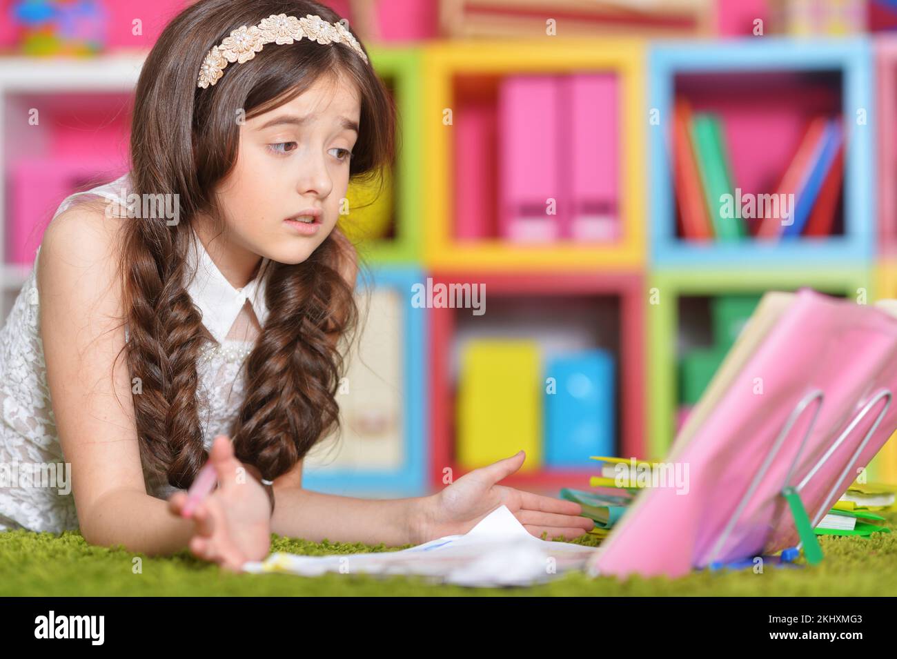 Portrait of cute little girl study at home Stock Photo - Alamy