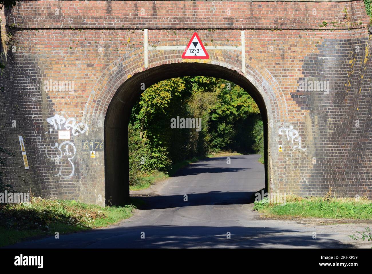 A railway bridge with limited headroom over a narrow country lane Stock ...
