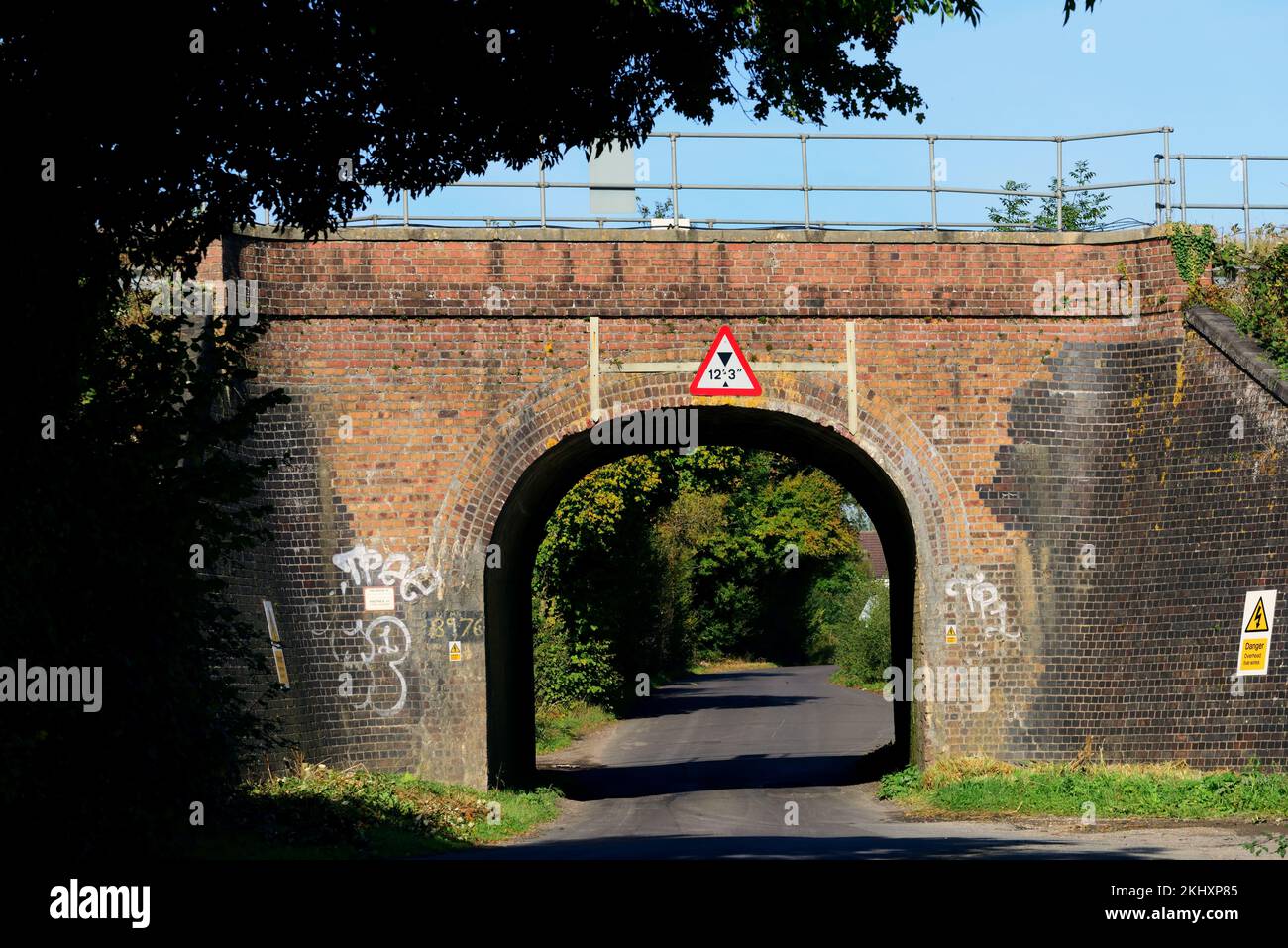 A railway bridge with limited headroom over a narrow country lane Stock ...