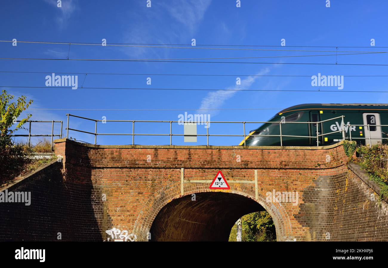 A railway bridge with limited headroom over a narrow country lane Stock ...