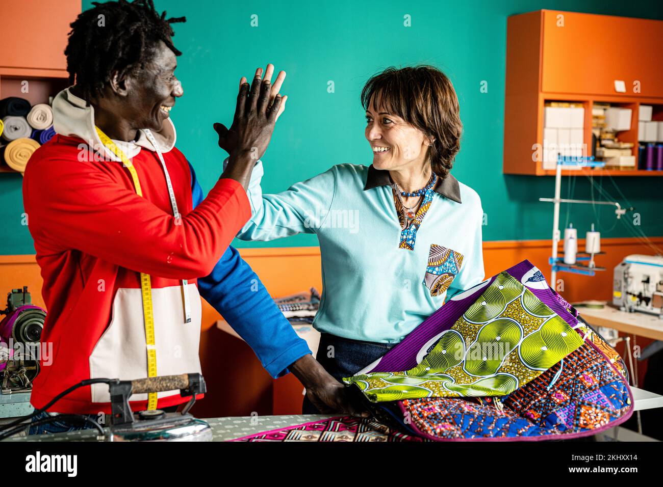 two tailors at work in their shop, team of clothes production small ...