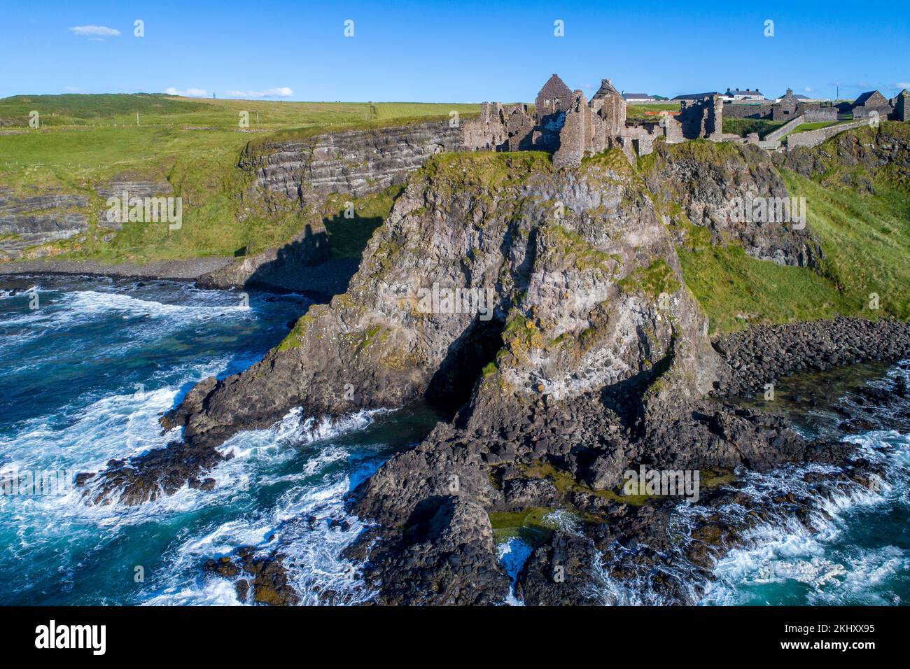 Ruins of medieval Dunluce Castle, cliffs, bays and peninsulas. Northern ...