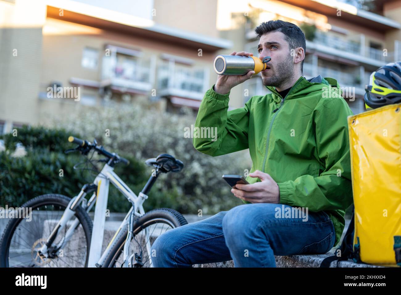 Young delivery man having rest, fast express delivery service worker ...