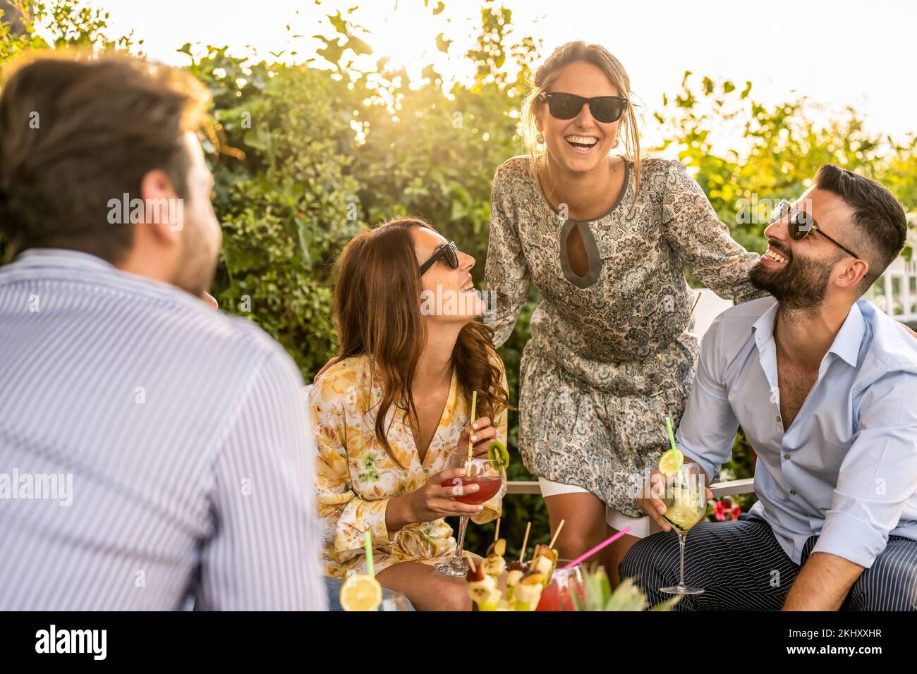 young group of 30s people having fun at a cocktail party outdoor ...