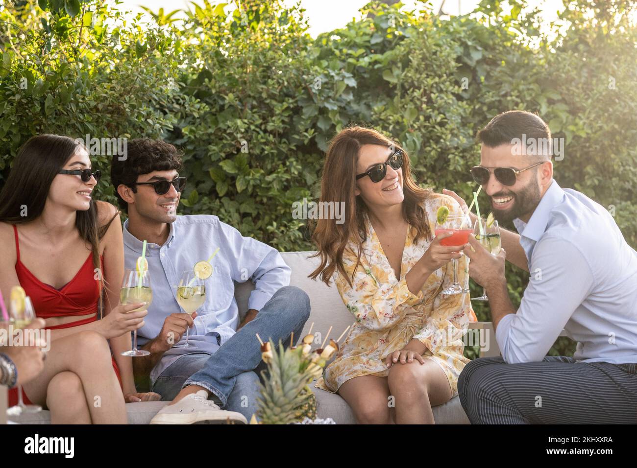 scene of people smiling, drinking cokctails and toasting happily ...