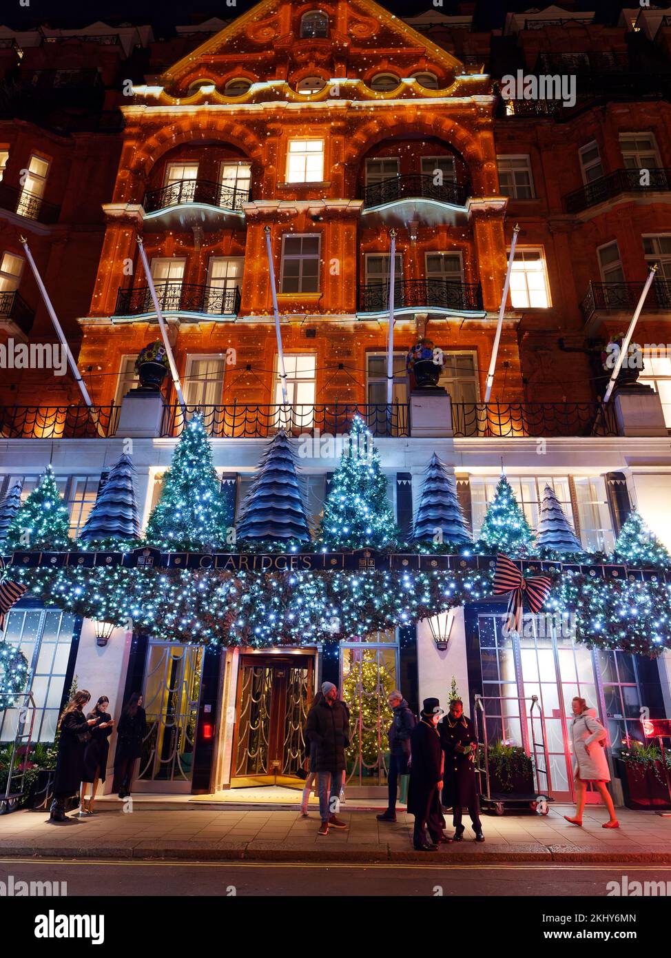 Claridge's iconic hotel Christmas display facade. Guests wait outside ...