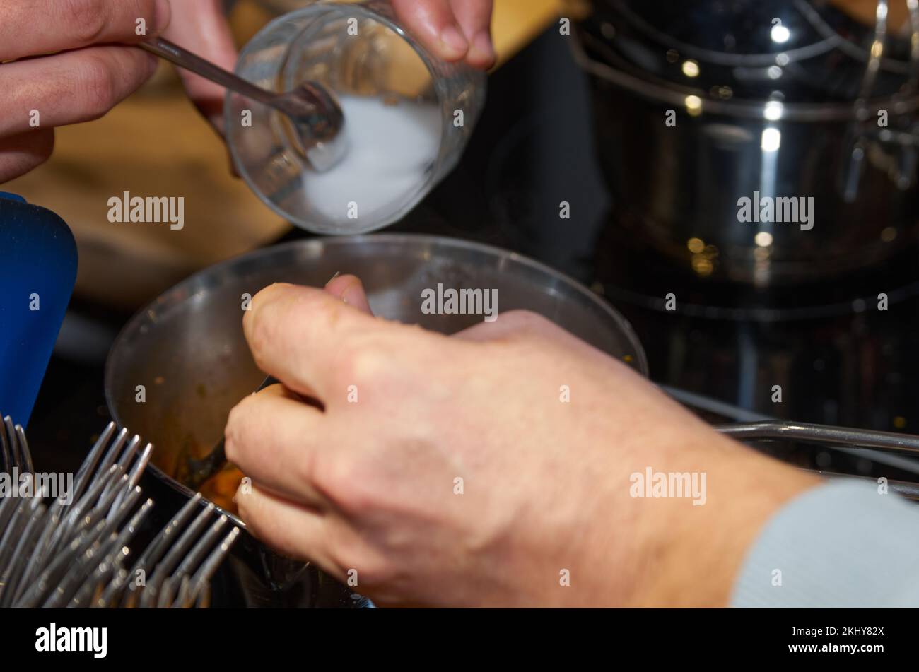 Cooking process: adding ingredients to the pot Stock Photo - Alamy