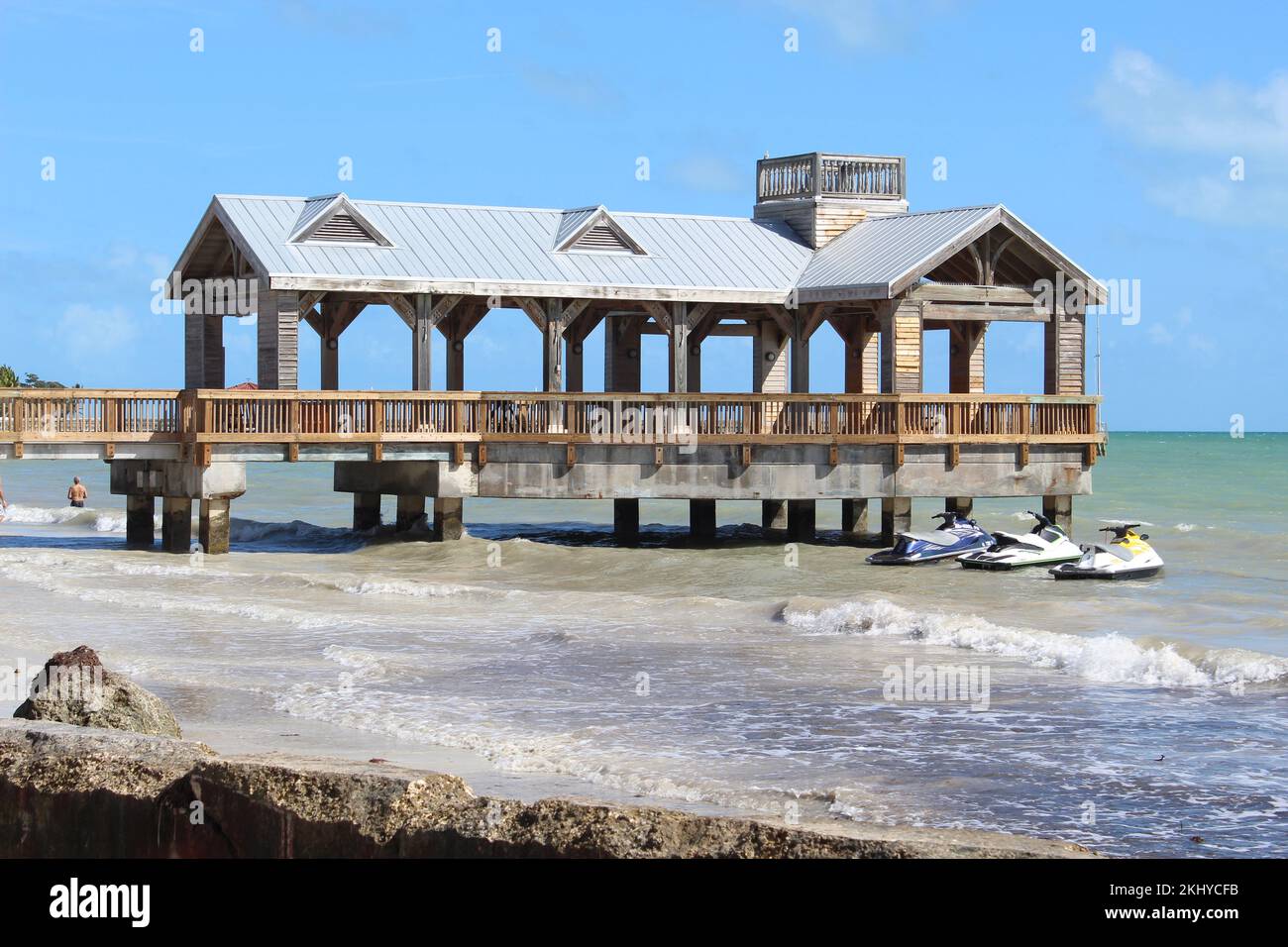 The Key West pier visible on the ocean shore with blue sky in the ...