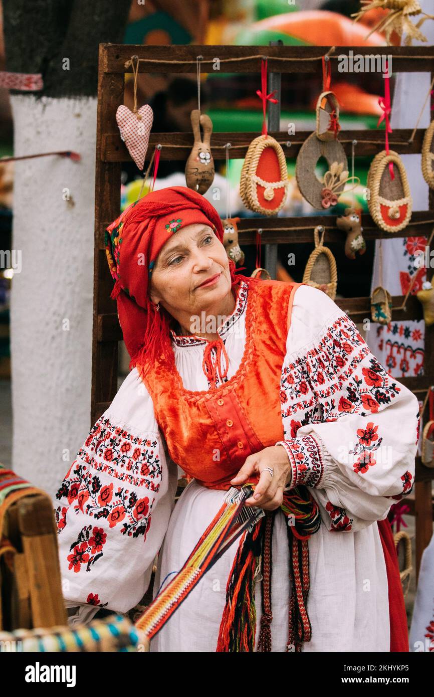 Adult Female Weaver In Traditional Embroidered Belarusian Clothes Shows ...