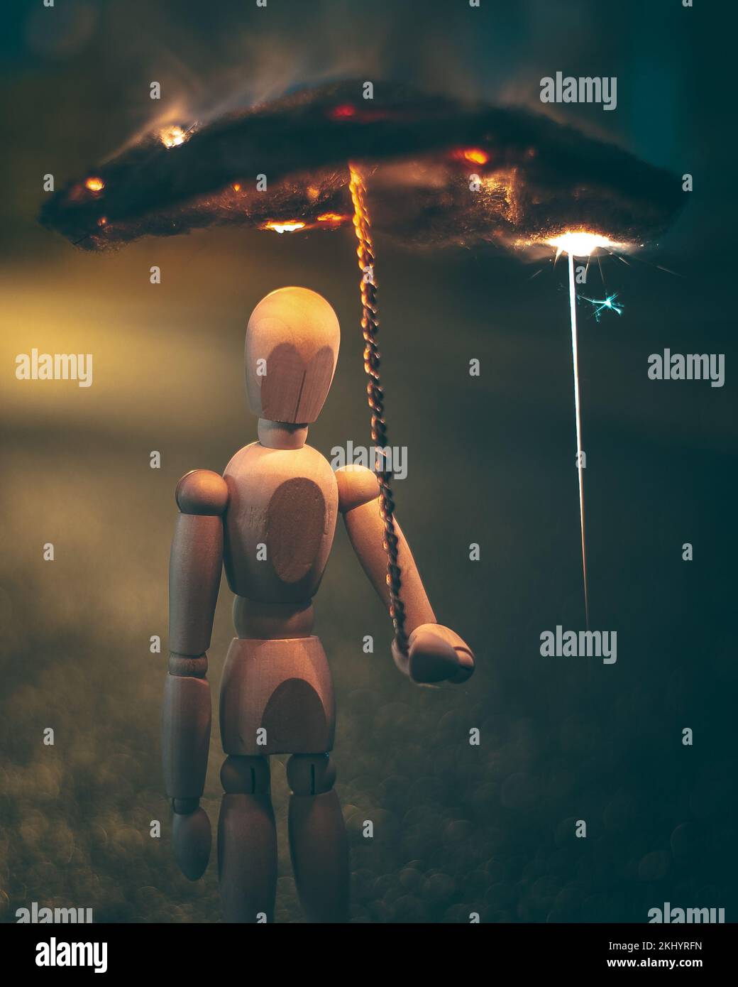 A vertical selective focus of a wooden puppet holding a 3D rendering of ...